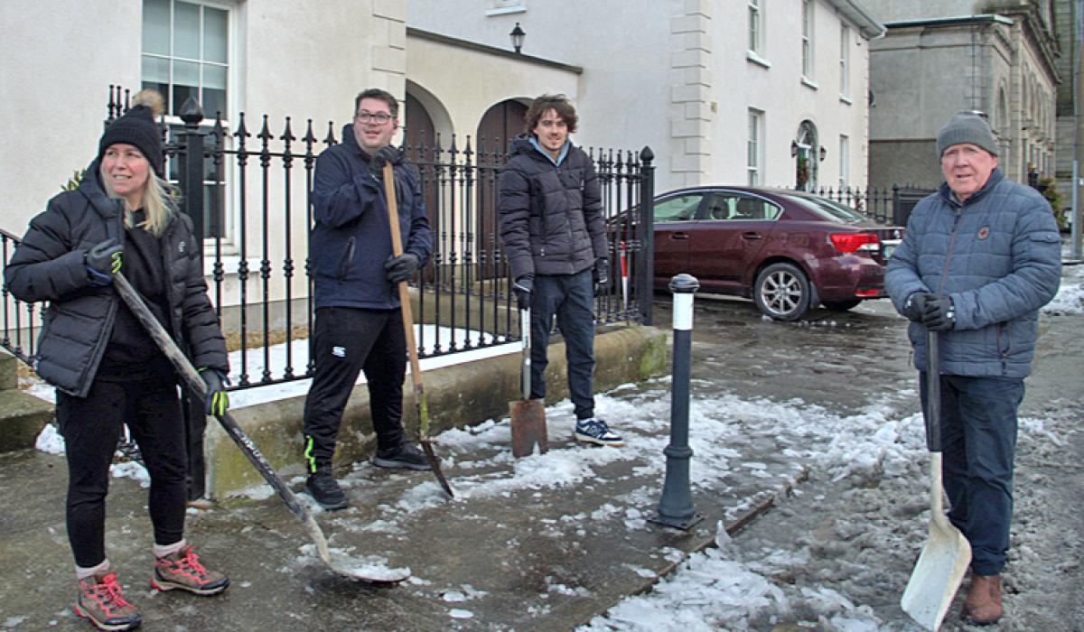 Hard at work shoveling snow and ice from footpaths in Carrick-on-Suir town centre - Tipperary Live